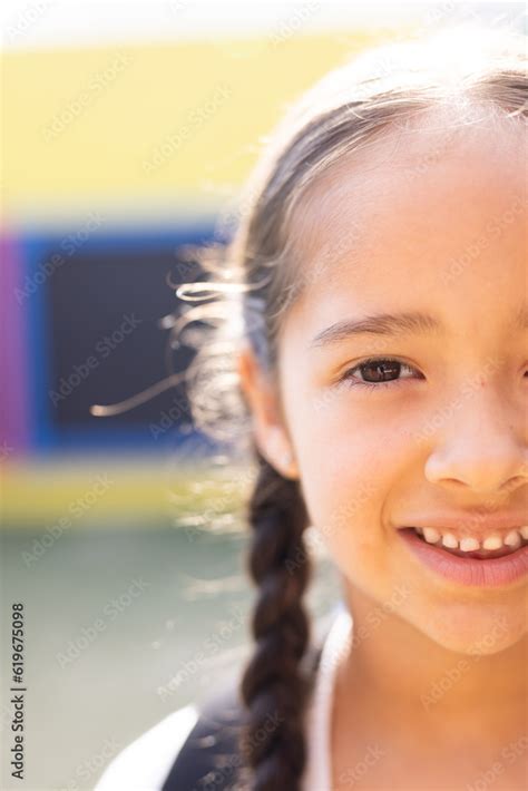 Vertical Half Face Portrait Of Smiling Cauasian Elementary Schoolgirl