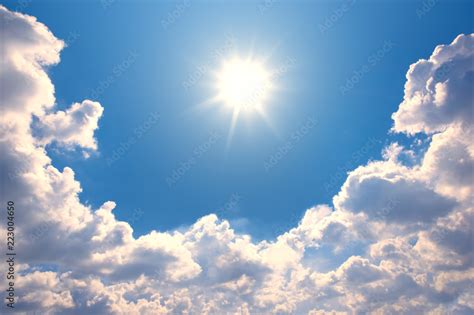 Blue Sky With Clouds And Sun Reflectionthe Sun Shines Bright In The