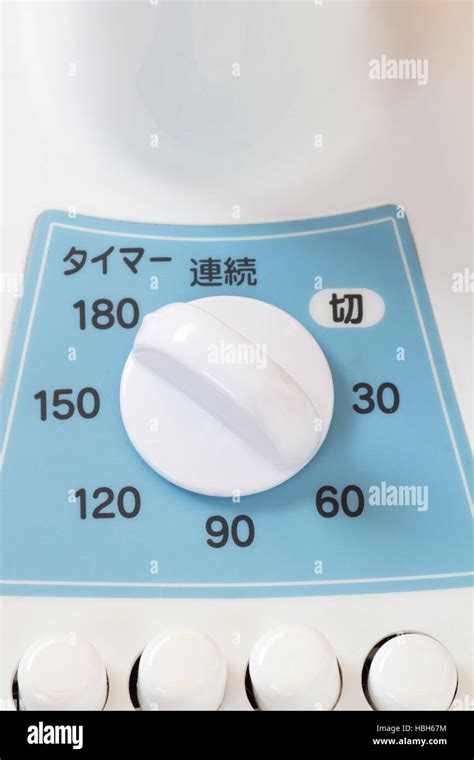 Analog Timer Device Of A Bule And White Japanese Electric Fan Stock
