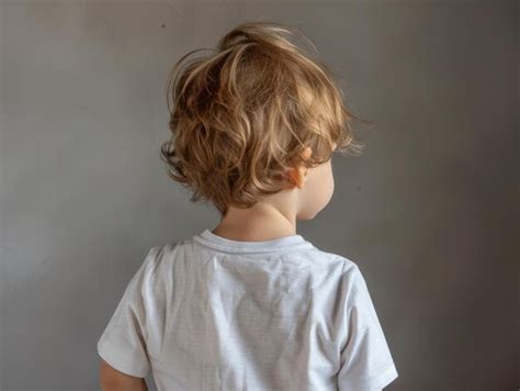 Premium Photo Young Boy Stands Facing Away From Camera Young Boy