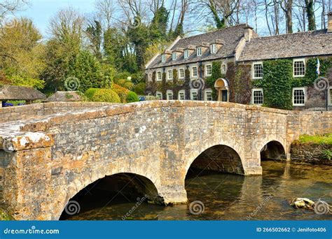 Bridge And Leafy Buildings Of The Cotswolds Village Of Bibury England