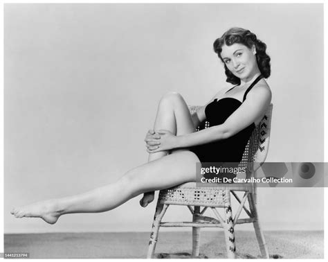 Actress Susan Cabot Sits On A Chair Wearing A Swimsuit In A Publicity