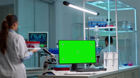 Team Of Scientists Working In Background Of Modern Laboratory Using