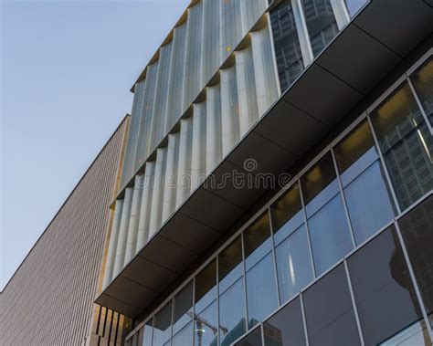 Modern Commercial Building Facade With Vertical Fins And Glass Windows