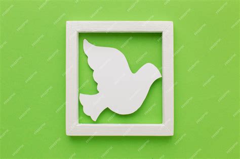 Free Photo Top View Of Paper Dove In Frame
