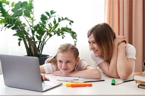 Premium Photo Mother Helping Daughter With Homework