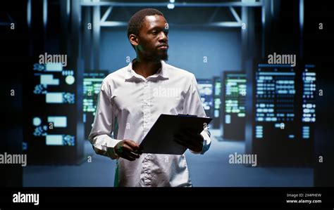 African American Engineer Doing Maintenance In Data Center Providing