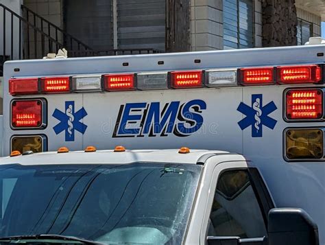 Close Up View Of Ems Ambulance With Flashing Lights During Daytime