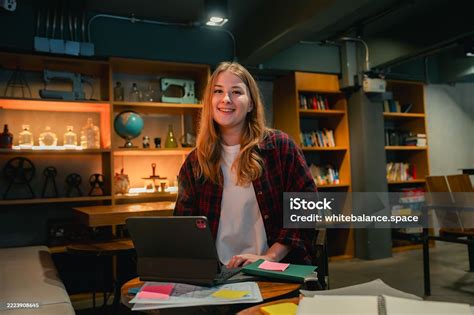 Hardworking College Student Studying Late At Night Focusing On Her