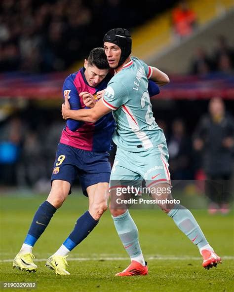 Robert Lewandowski Of Fc Barcelona And Robin Le Normand Of Atletico