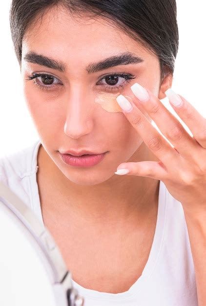 Premium Photo Young Woman Apply Concealer Under The Eye