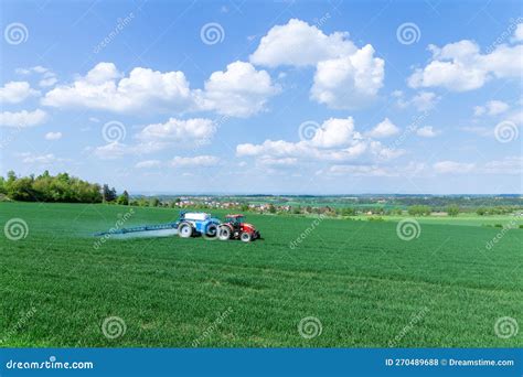 With The Help Of A Tractor Wheat Is Sprayed With Fertilizers Or Herbicides In Rural Areas