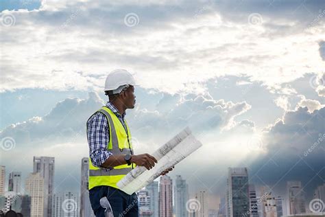 Engineers With Draft Plan Of Building On Constructing Site Engineer
