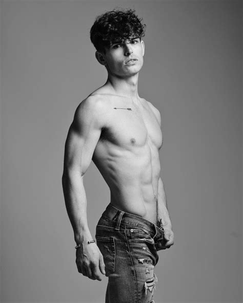 A Shirtless Young Man Posing For A Photo