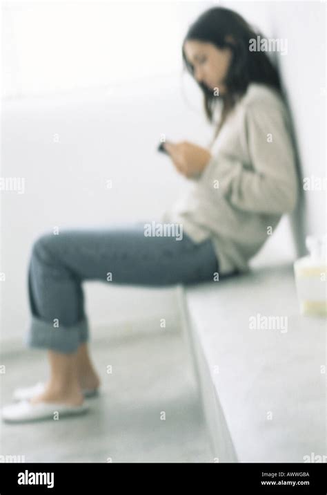 Girl Sitting Against Wall Side