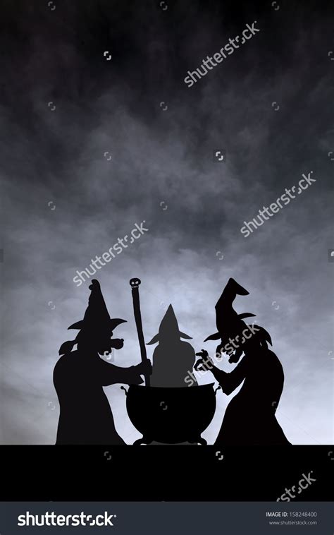 Three Witches Gathering To Brew Magic Potion In A Cauldron On Halloween