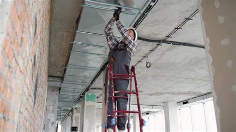 Worker Mounts Ceiling Ventilation System In Office 69042966 Stock Video
