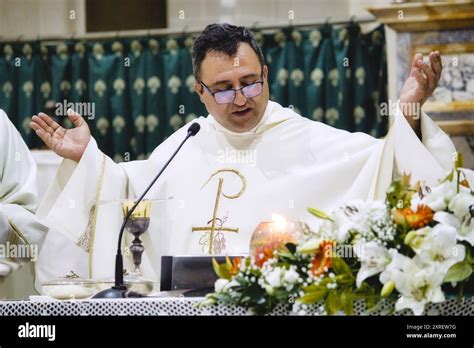 A White Caucasian Catholic Priest Delivering Eucharistic Prayer During A Sunday Mass In A Church