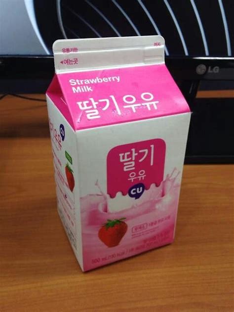 Carton Of Strawberry Milk On Wooden Table
