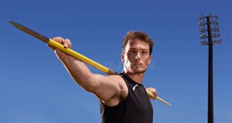 This Is Going The Distance A Lone Man Throwing A Javelin Outside Stock Image Image Of