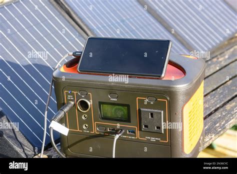 Mobile Phone Being Charged By A Solar Generator Battery Pack With Solar