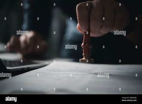 Person Using A Rubber Stamp A Document Approval Certification Or Official Validation In