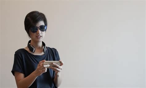 Premium Photo Woman Wearing Sunglasses While Using Mobile Phone