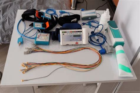 Stationary Polysomnography System Setup On Bedside Table With Cables