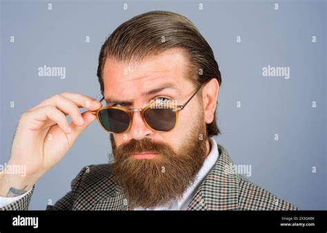 Closeup Portrait Of Serious Attractive Man Takes Off Sunglasses