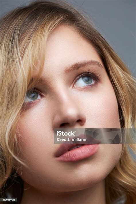 Close Up Of Gorgeous Caucasian Blond Woman With Blue Eyes Looking Up