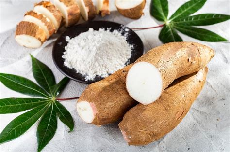 Premium Photo Pile Of Cassava Root And Cassava Flour On A Gray And