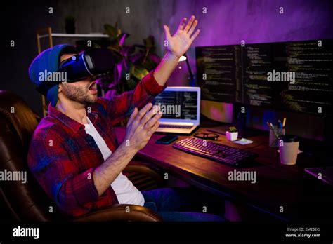 Photo Of Smiling Funny Coder Dressed Hat Eyewear Creating Video 3d Game Modern Gadget Indoors