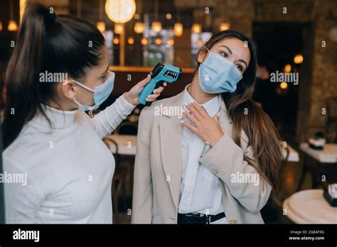 Woman Measuring Body Temperature With Contactless Body Thermometer Stock Photo Alamy