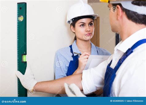 Specialist And Assistant Working With Wall In New Building Stock Image