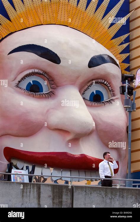 Unsuspecting Cellphone User About To Be Swallowed Alive By The Giant