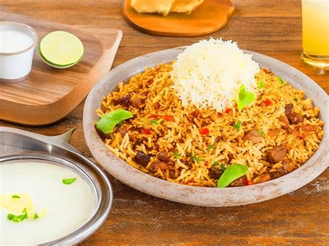 Premium Photo Kassi Biryani Platter White Cool Drink On Wood Table