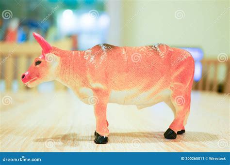 Soft Focus Of A Plastic Toy Bull On A Wooden Table Stock Image Image