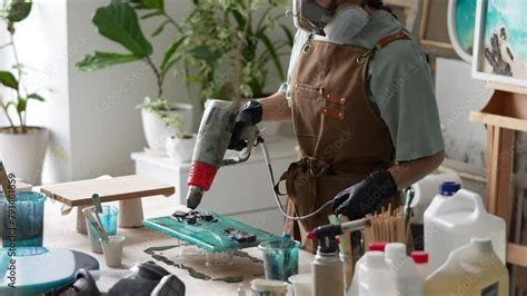 Artist Girl Works With Flowable Epoxy Resin Creates Paintings In Studio Artist Girl Works With Flowable Epoxy Resin Creates Paintings In Studio