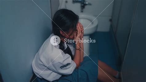 An Asian Teenager Cries In The School Bathroom After Being Bullied