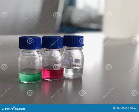 Bottles And Blue Cap With Green Red And Clear Solution Buffer Ph 4 7 And 10 On Bench
