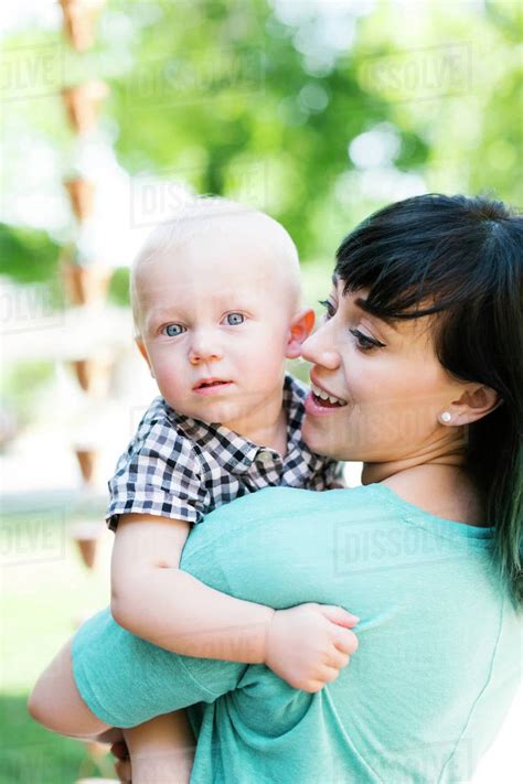 Mother Carrying Baby Boy Stock Photo Dissolve