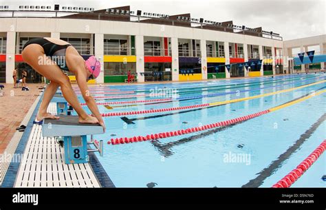 A Girl Is Ready To Dive Into Water On A Swimming Pool During Her