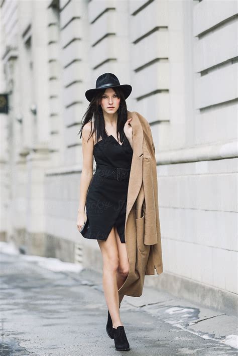 A Beautiful Woman Walking With Her Jacket Slung Over Her Shoulder By Stocksy Contributor A