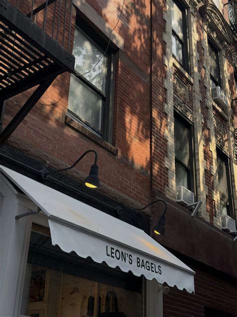 A Storefront With A White Awning On A City Street Photo Free Building