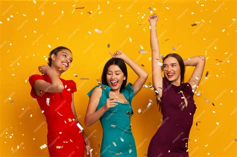 Premium Photo Three Girls Dancing Having Party With Confetti Over
