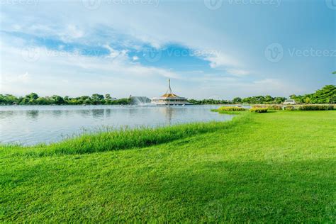Lake And Green Grass Field At The Park Watercycle In Lake Near