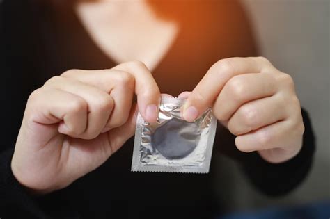 Premium Photo Condom Ready To Use In Female Hand Give Condom Safe Sex