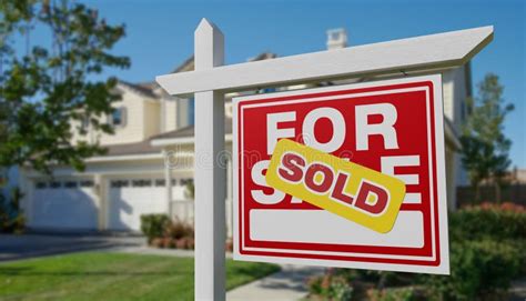 Sold For Sale Real Estate Sign In Front Of Beautiful House Stock Image