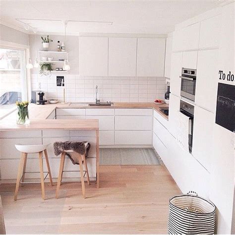 Scandinavian Kitchen Design With White Cabinets And Wooden Floors
