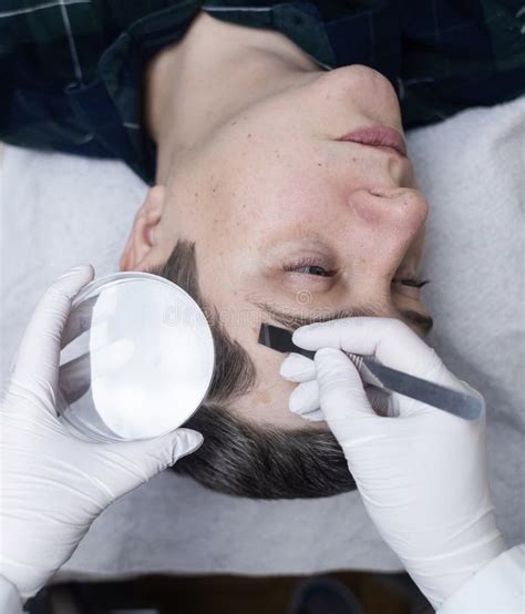 A Dermatologist Takes A Skin Scraping And Tests For Demodicosis And